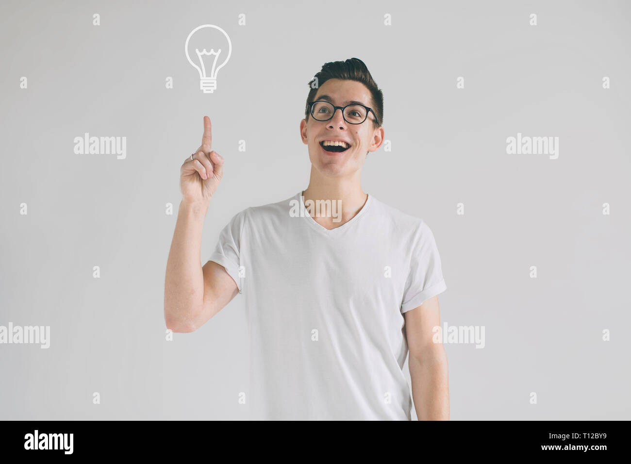 Young smiling man having a good idea. Portrait of an excited nerd with ...