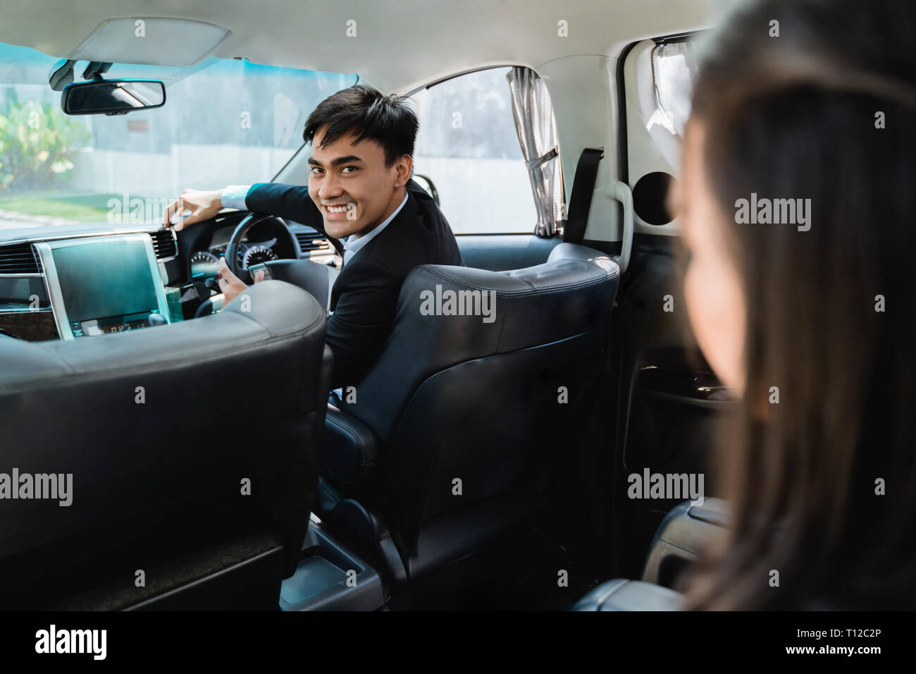driver in his suit driving luxurious car Stock Photo - Alamy