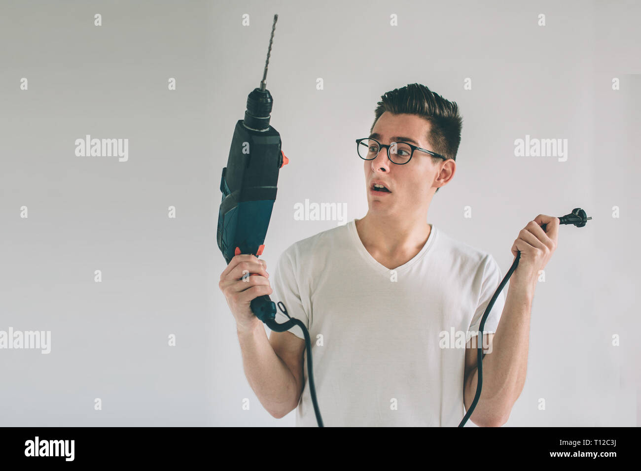 Funny portrait upset craftsmen. Nerd is wearing glasses.. Does not know ...