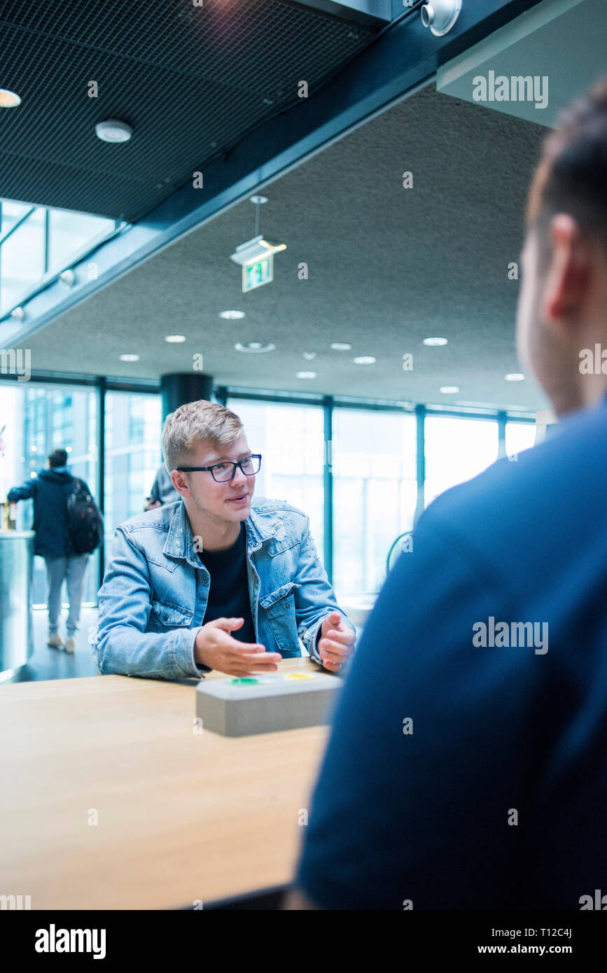 Group people sitting around table hi-res stock photography and images ...