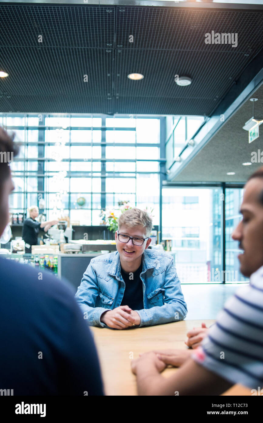 Sat around table discussion hi-res stock photography and images - Alamy