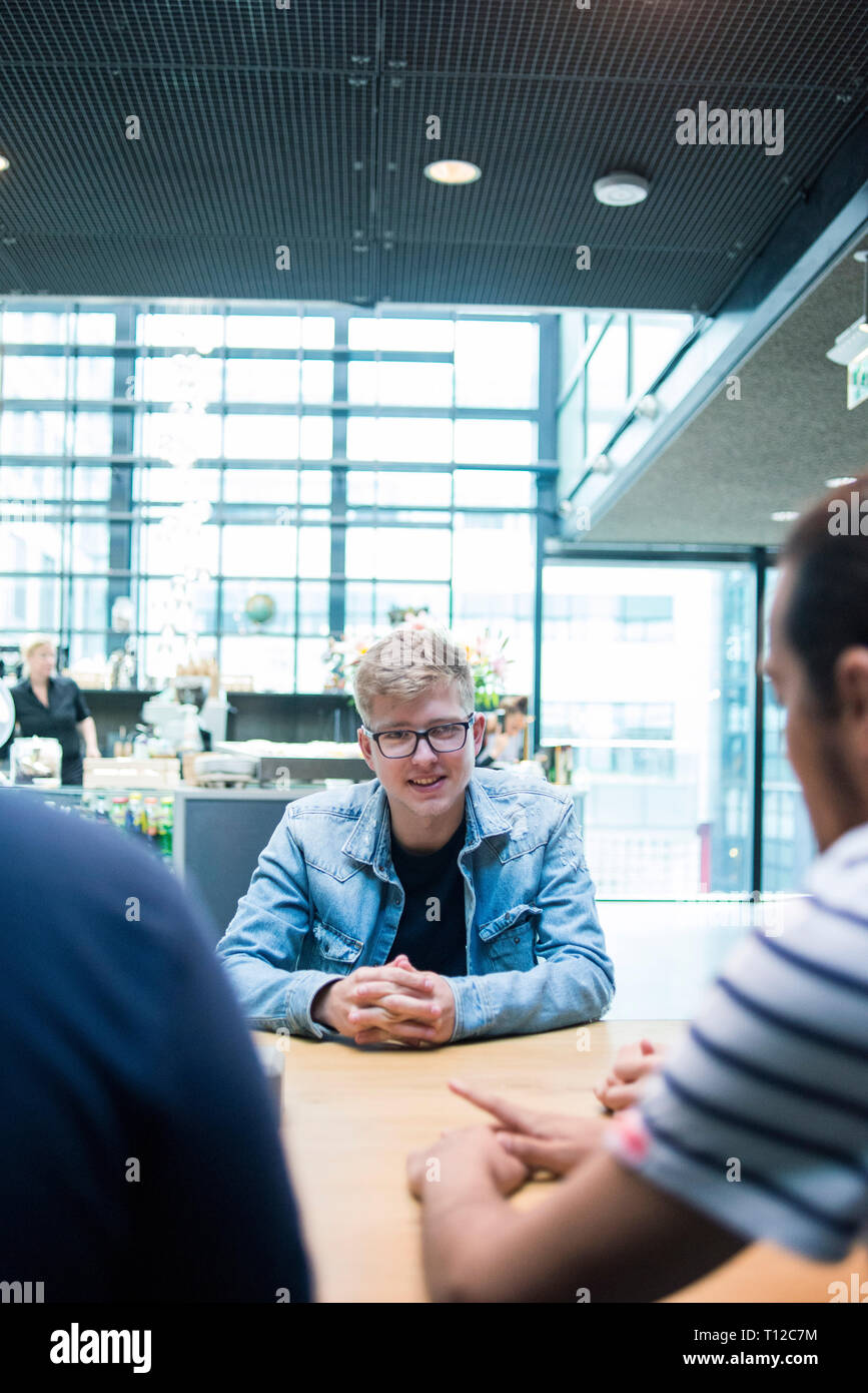 Sat around table discussion hi-res stock photography and images - Alamy