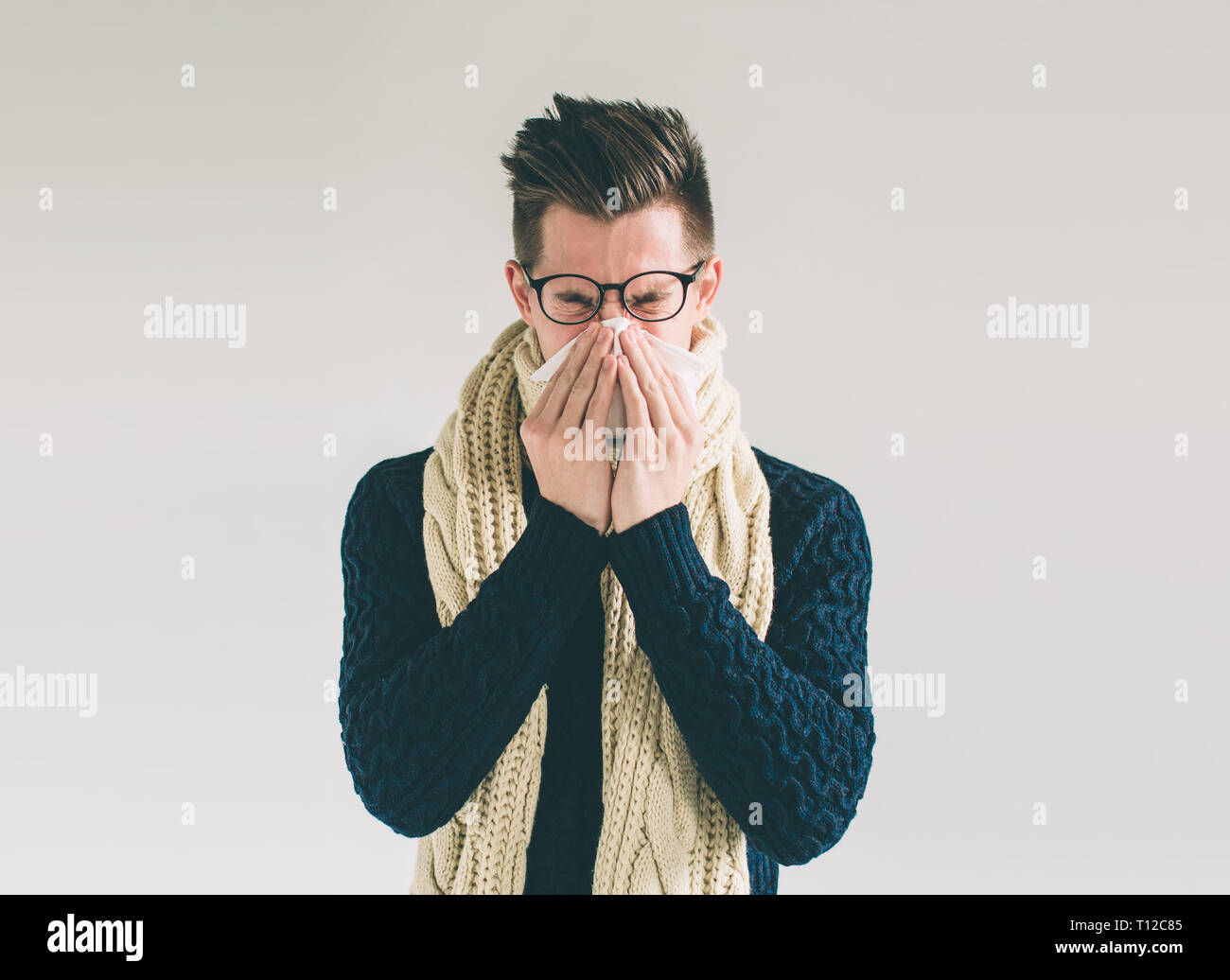 studio picture from a young man with handkerchief. Sick guy isolated ...