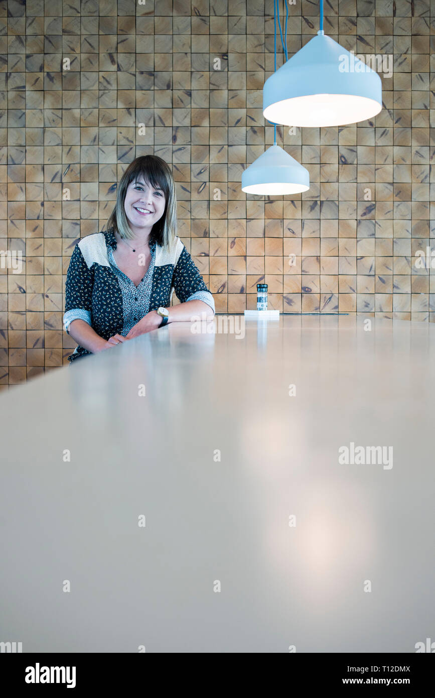 A young woman poses at a table in a cafe / restaurant Stock Photo - Alamy