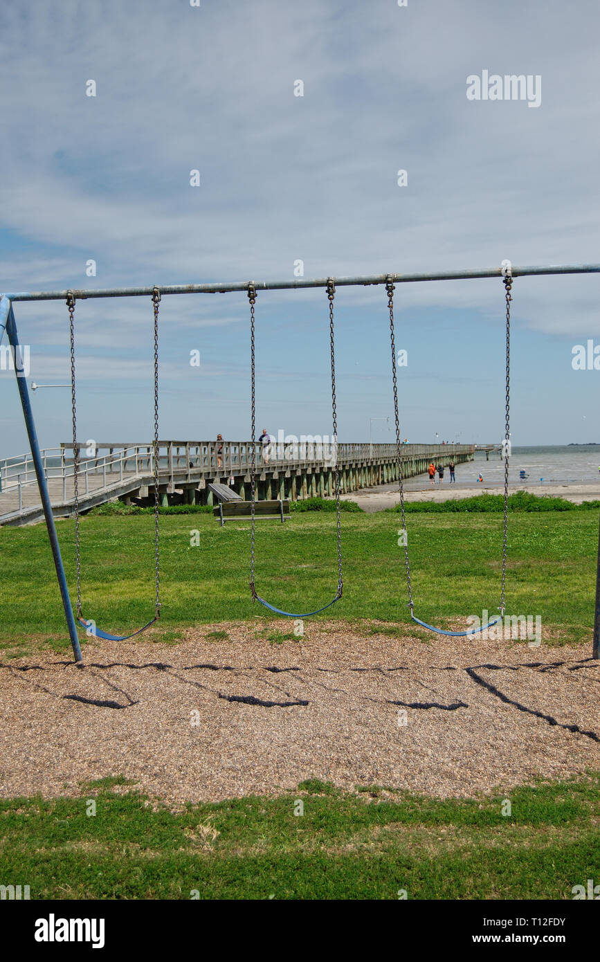 A playground swing set on the beach Stock Photo - Alamy