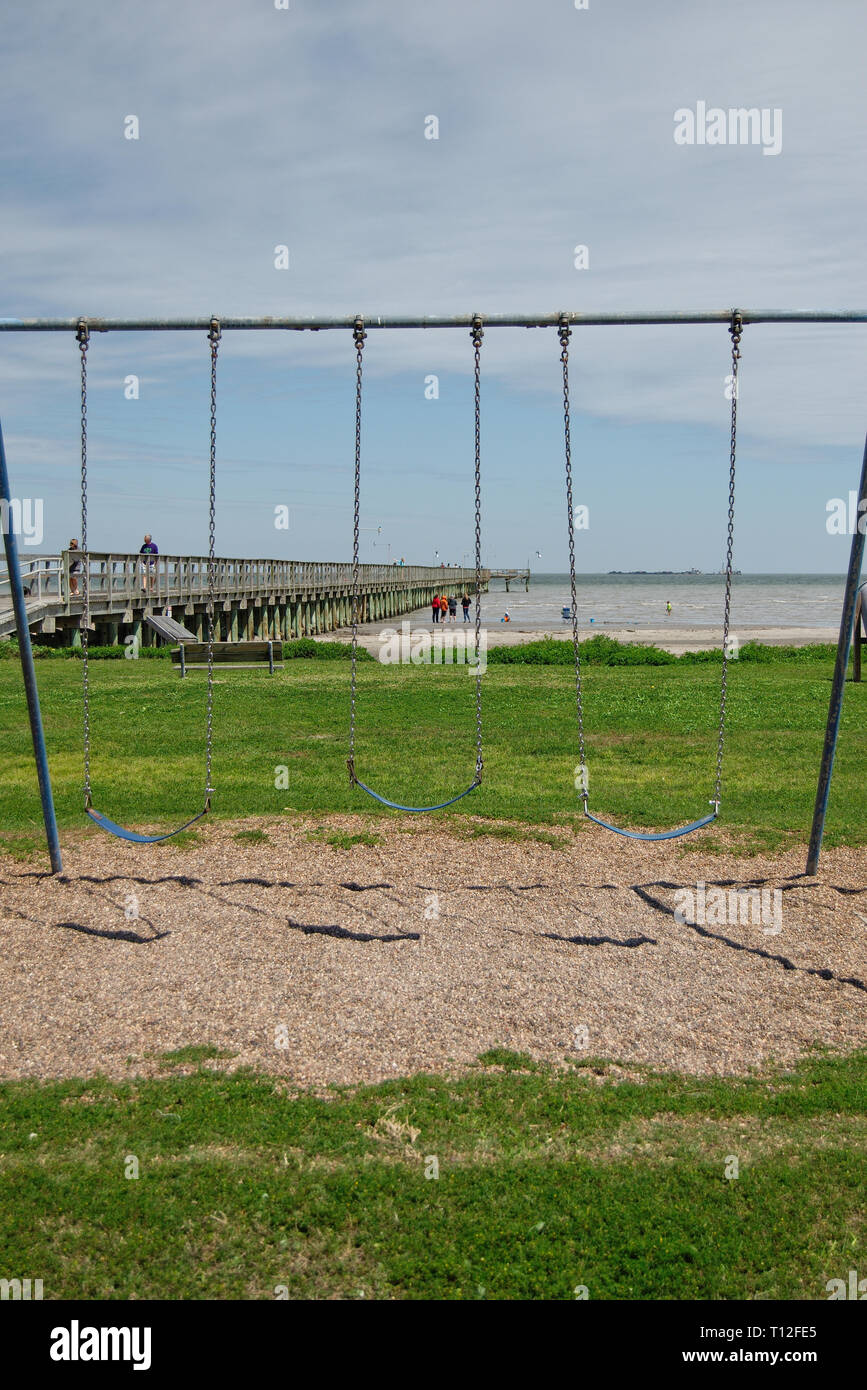 A playground swing set on the beach Stock Photo - Alamy