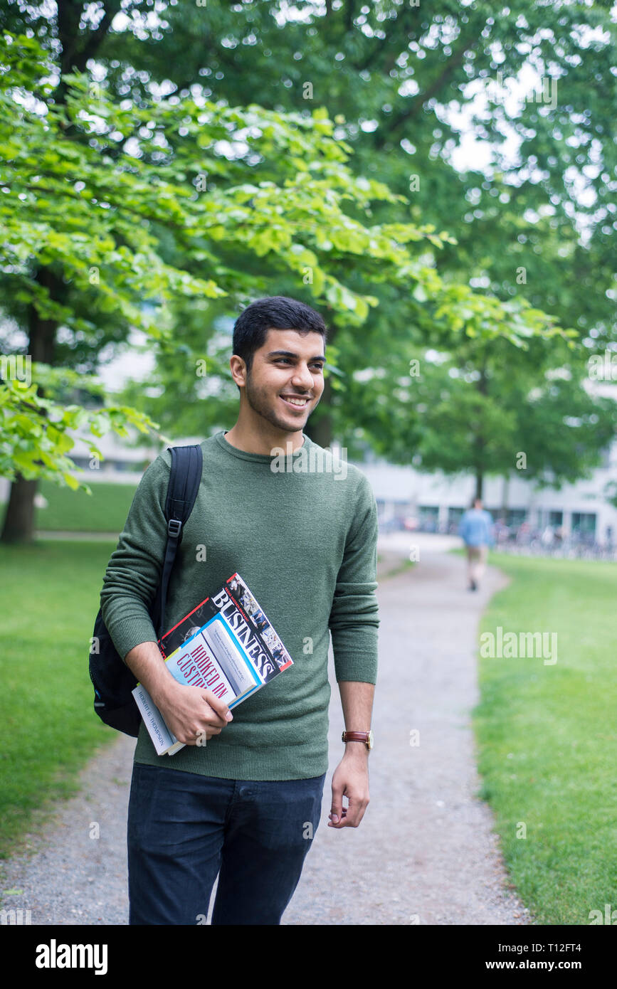 A male international student stand outside at a Ducth college campus in ...
