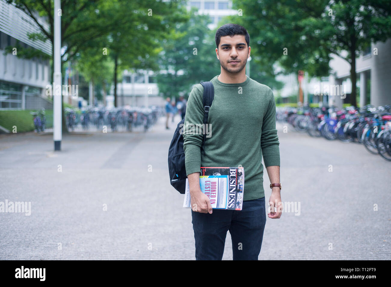 A male international student stand outside at a Ducth college campus in ...