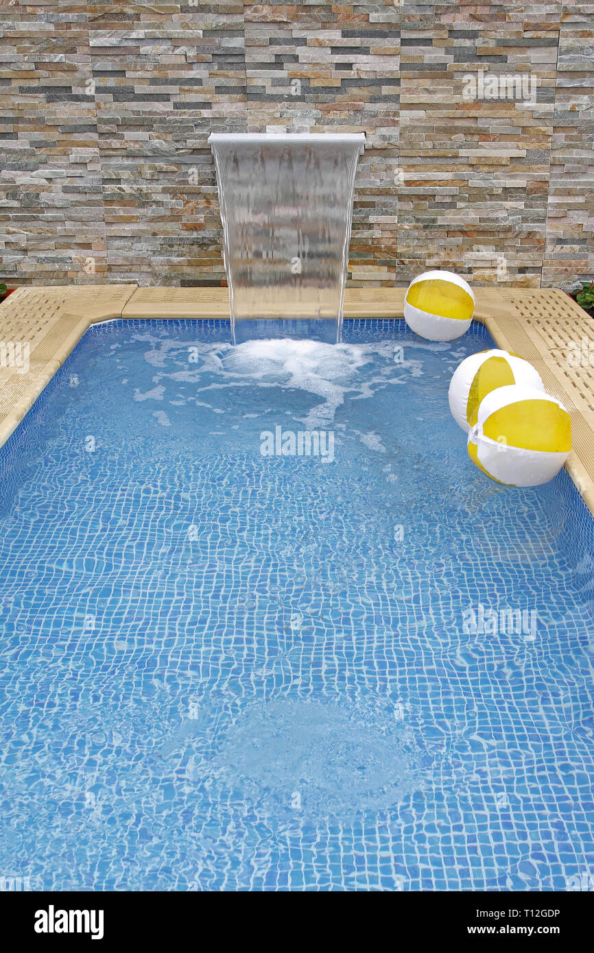 Small Modern Spa Swimming Pool With Waterfalls Stock Photo - Alamy