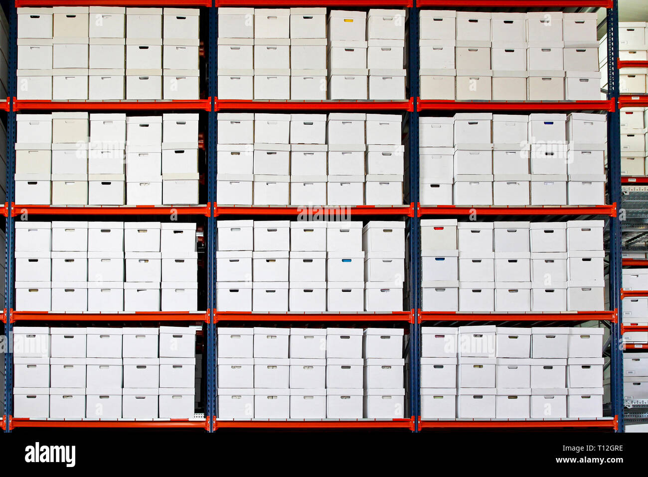 Big shelf with white storage boxes in warehouse Stock Photo - Alamy