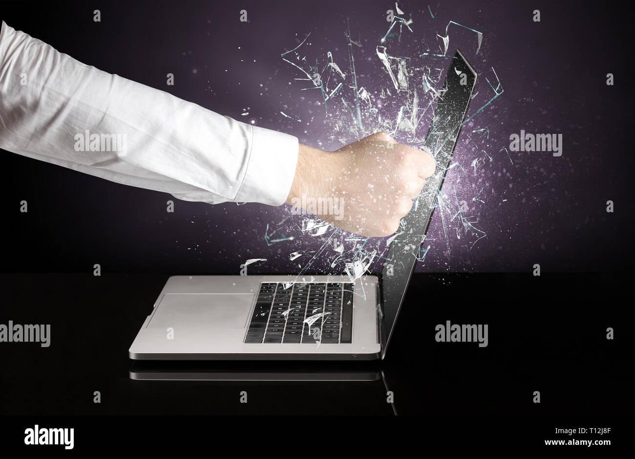 Hand hitting strongly laptop screen glass Stock Photo - Alamy