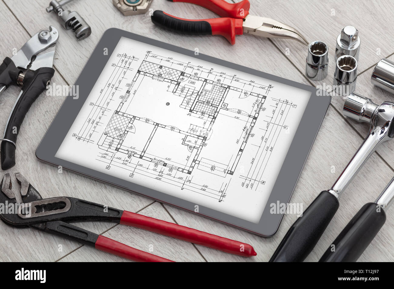 Tablet with construction tools and blueprint concept Stock Photo - Alamy