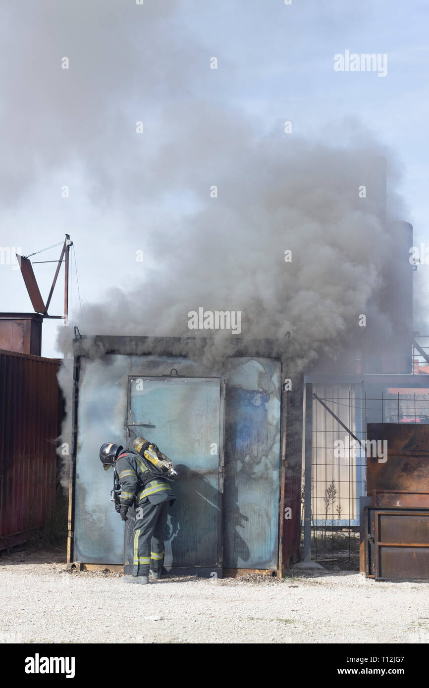 Firefighter putting out fire training station extinguisher backdraft ...