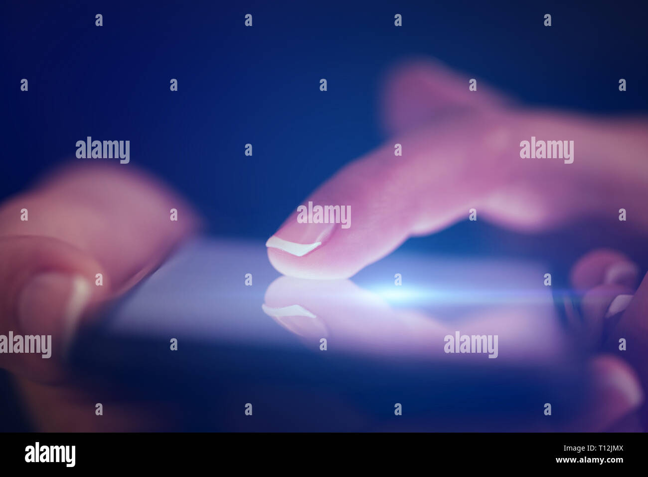 Finger touching phone with dark background with copyspace Stock Photo ...