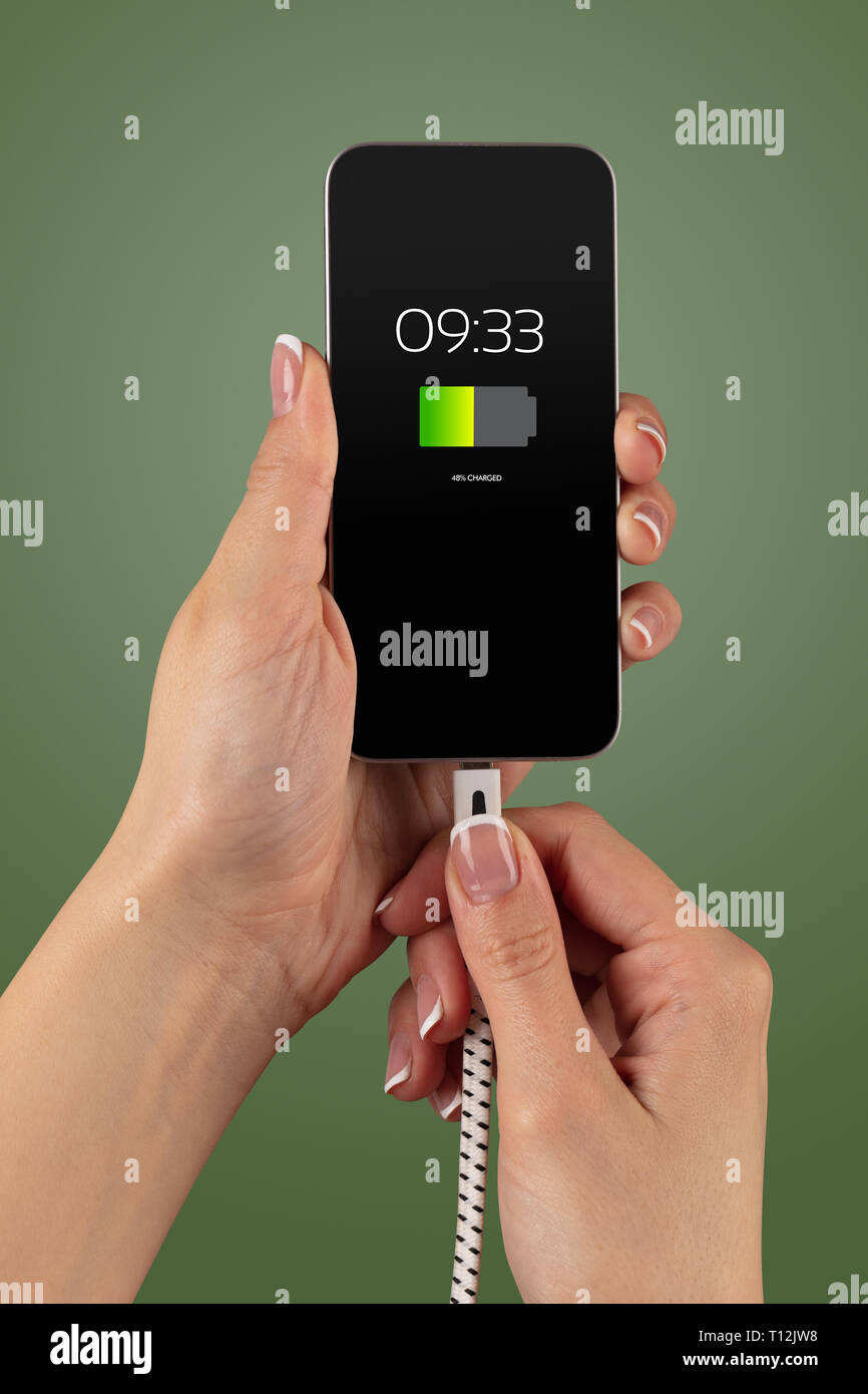 Elegant hand charging smartphone with low battery Stock Photo - Alamy
