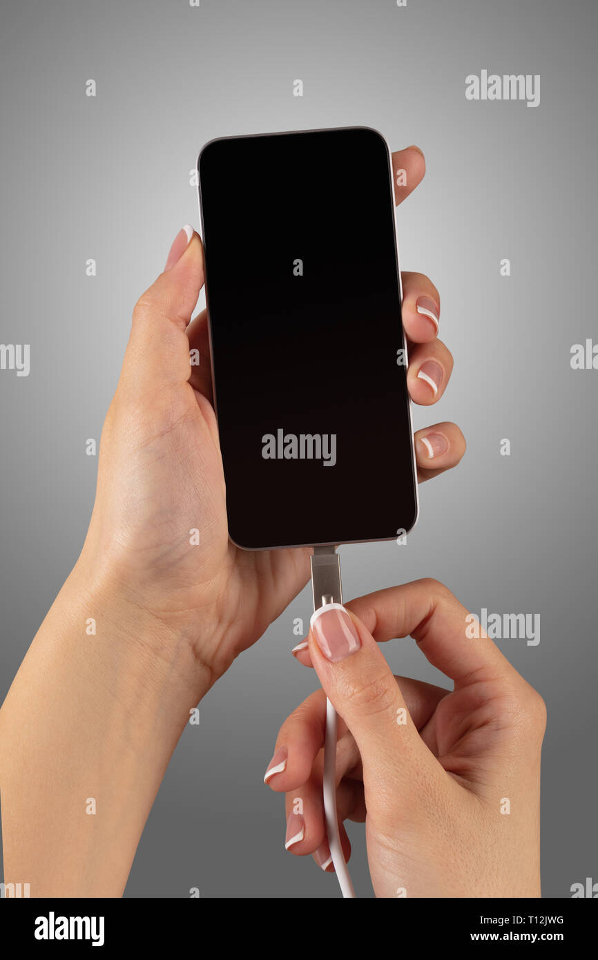 Close-up view of hand charging smartphone Stock Photo - Alamy