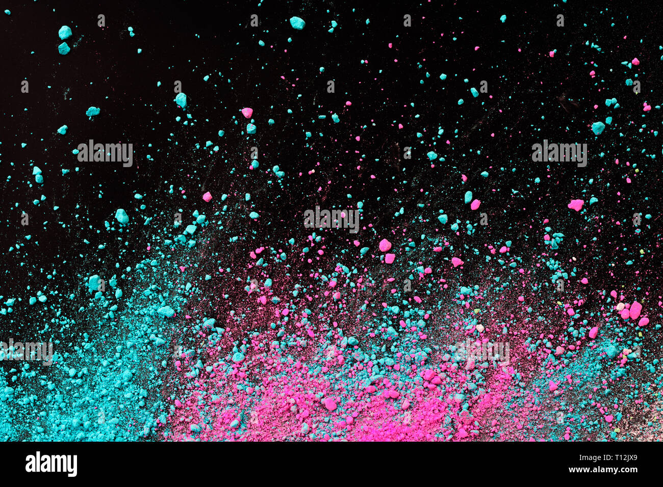 A splatter of pastel natural colored pigment powder on black background ...