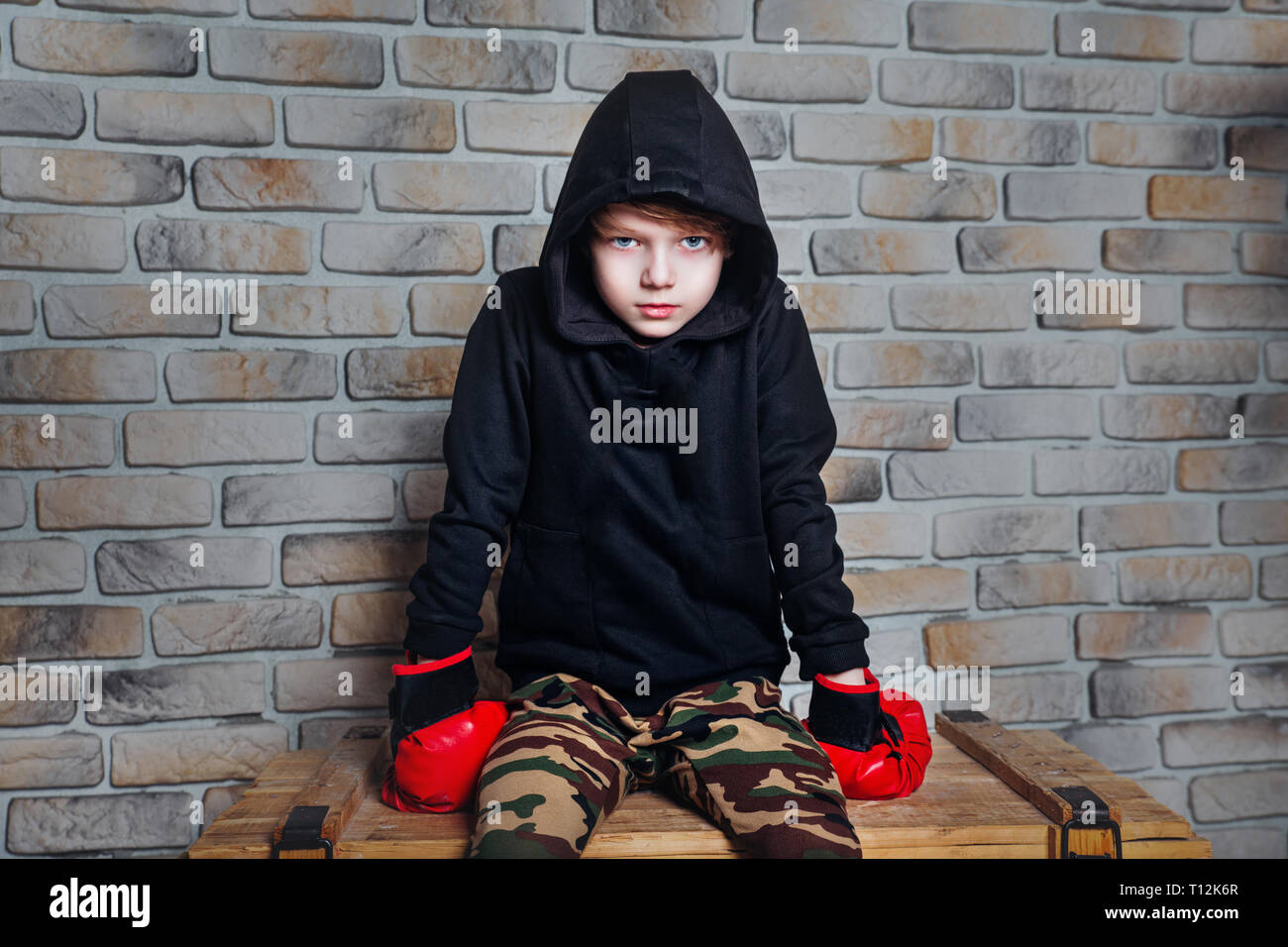 Little boy boxer with blonde hair dressing in black sweatshirt wearing ...