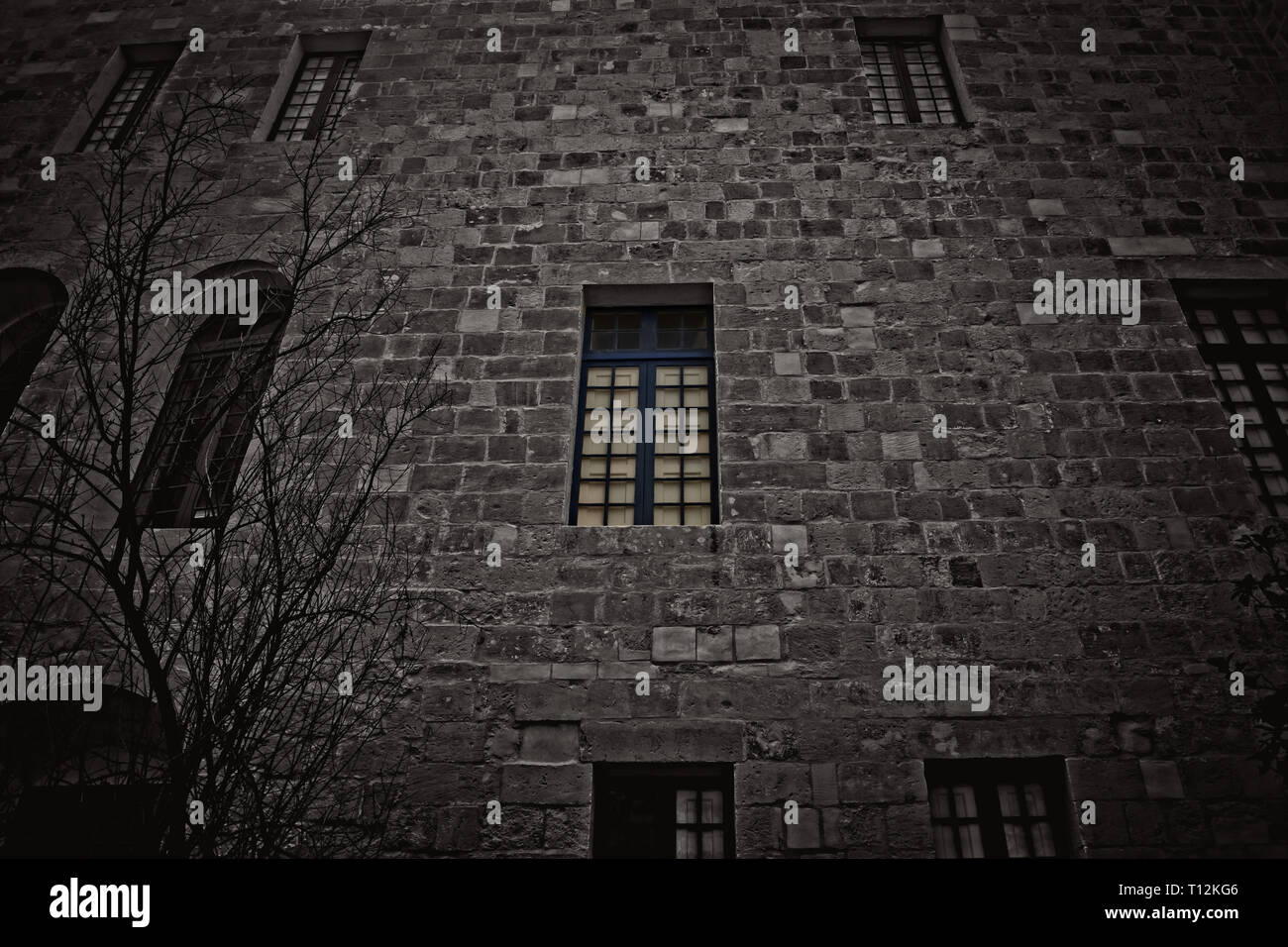 A blue window in a high wall in black and white Stock Photo - Alamy
