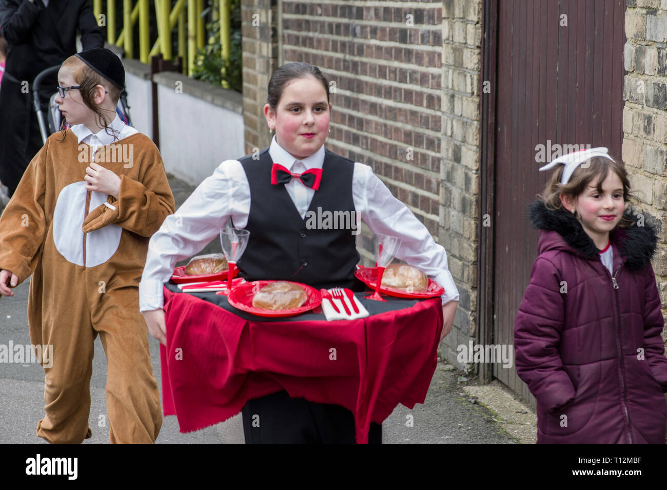 Girl in fancy dress costume with bagels on a red tablecloth for the ...