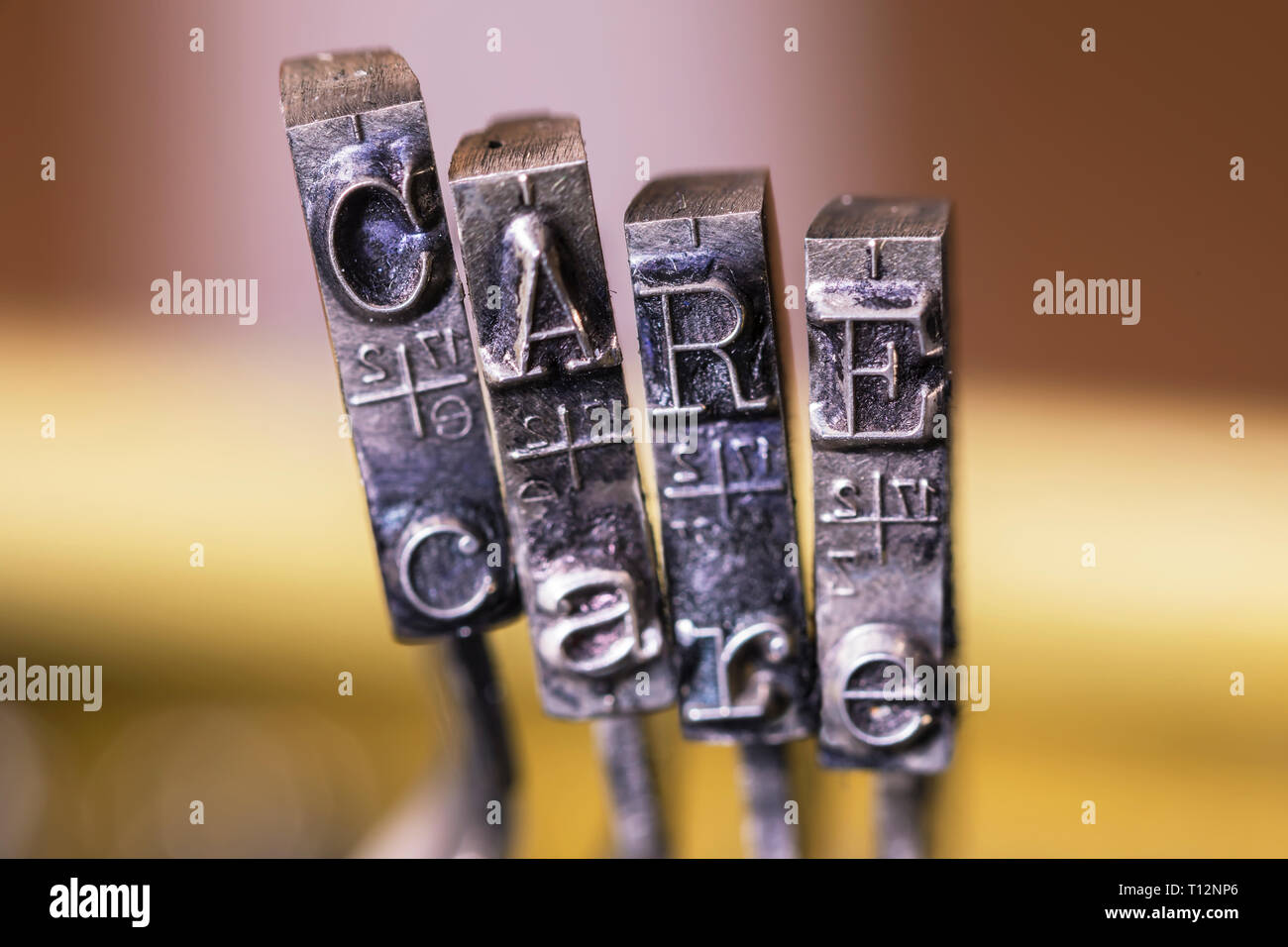 Macrophotography of typewriter hammers with CARE word Stock Photo - Alamy