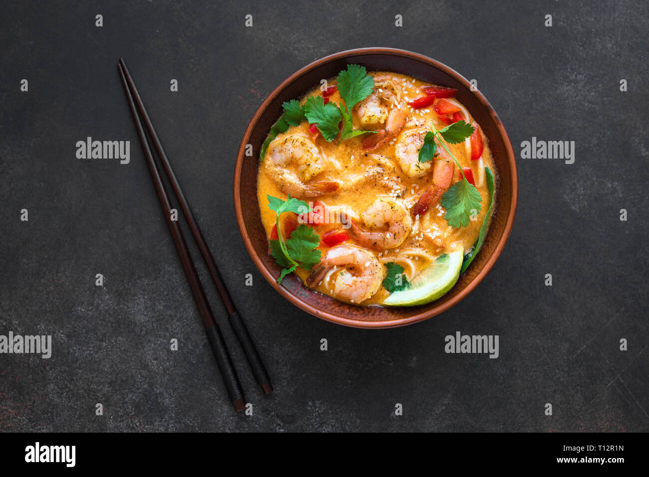 Laksa Shrimp Soup. Prawn laksa soup on black background, top view, copy ...