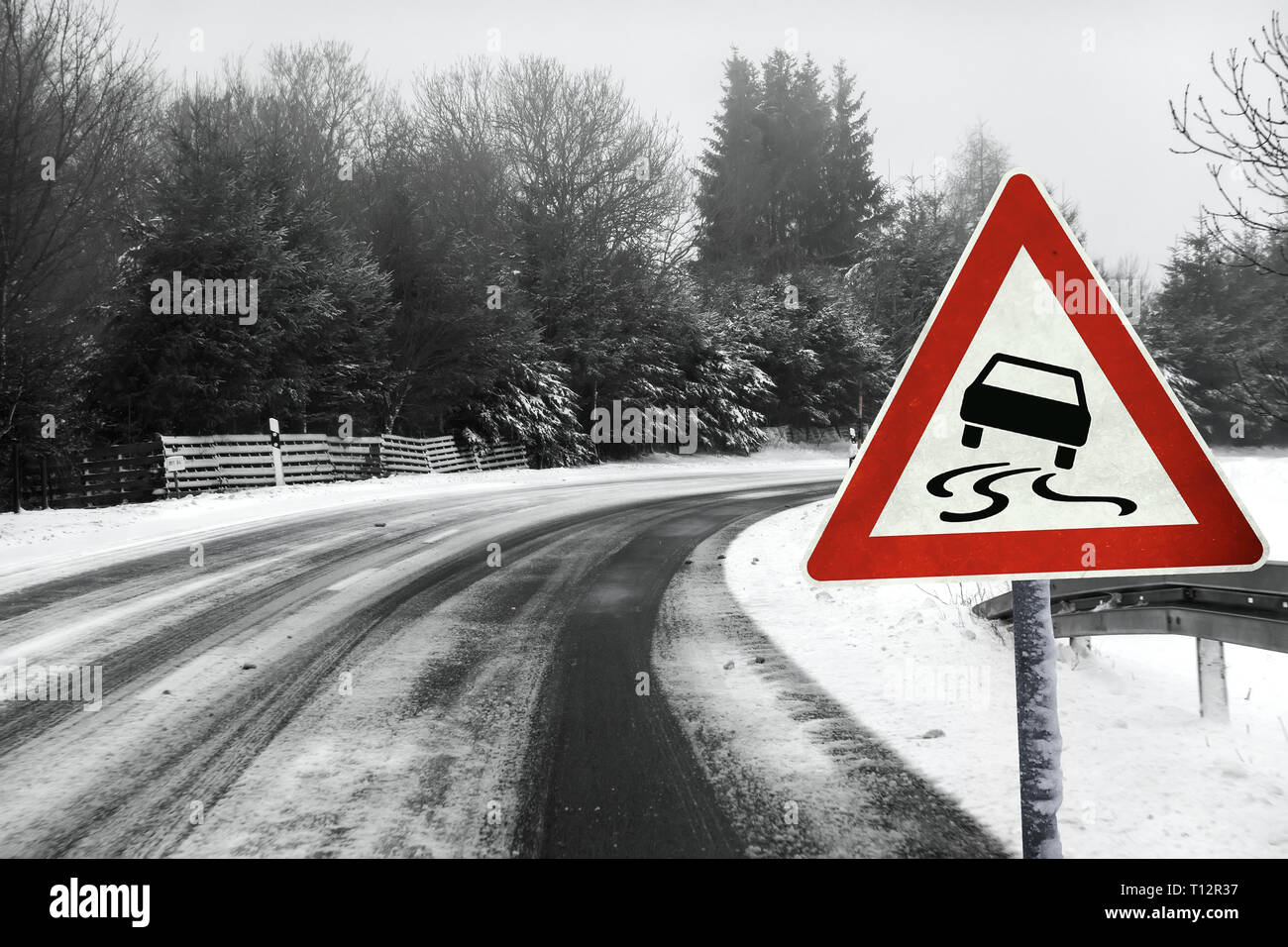 Snowy curvy road with traffic sign Snowy curvy road with traffic sign ...