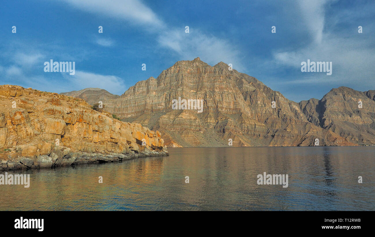 Beautiful mountains reflected in the water. Fjords on the Musandam ...