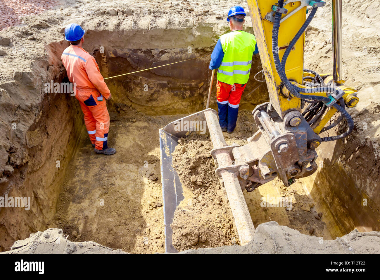 Workers are using metal measure tape, meter to check measurement in ...