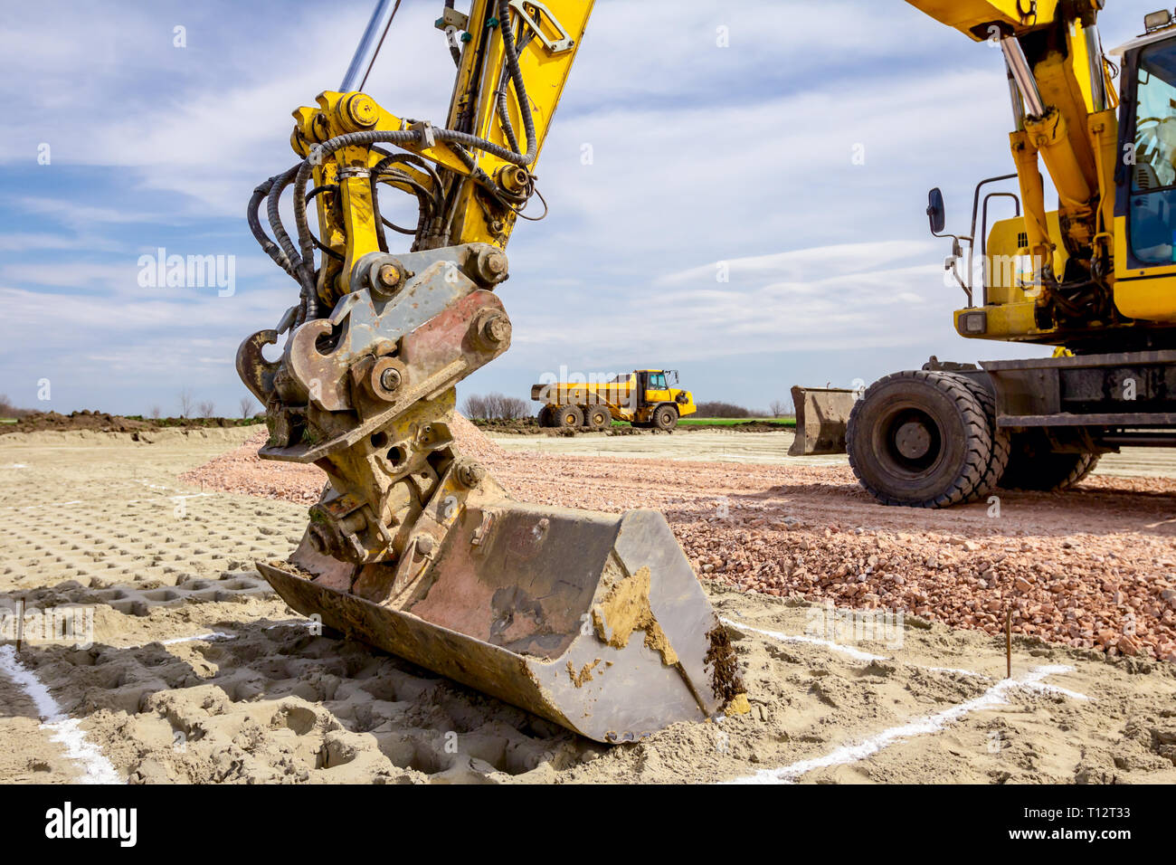 Excavator will excavate square trench that is marked with white powder ...