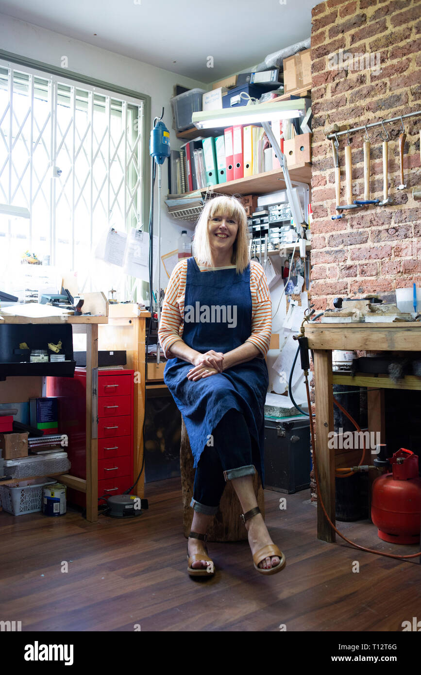A female creative artist poses in her studio Stock Photo - Alamy