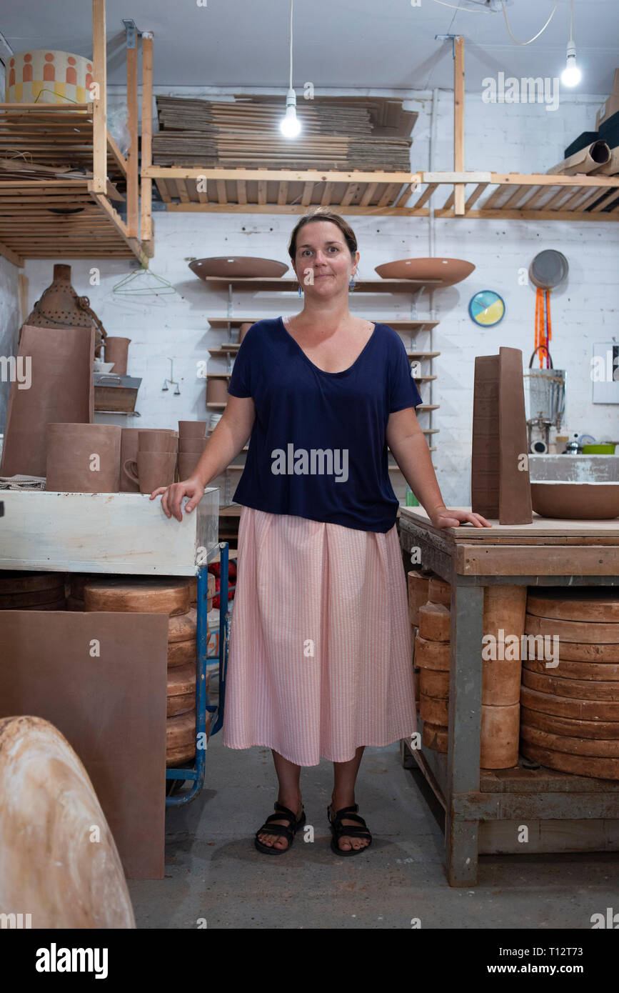 A female creative artist poses in her studio Stock Photo - Alamy