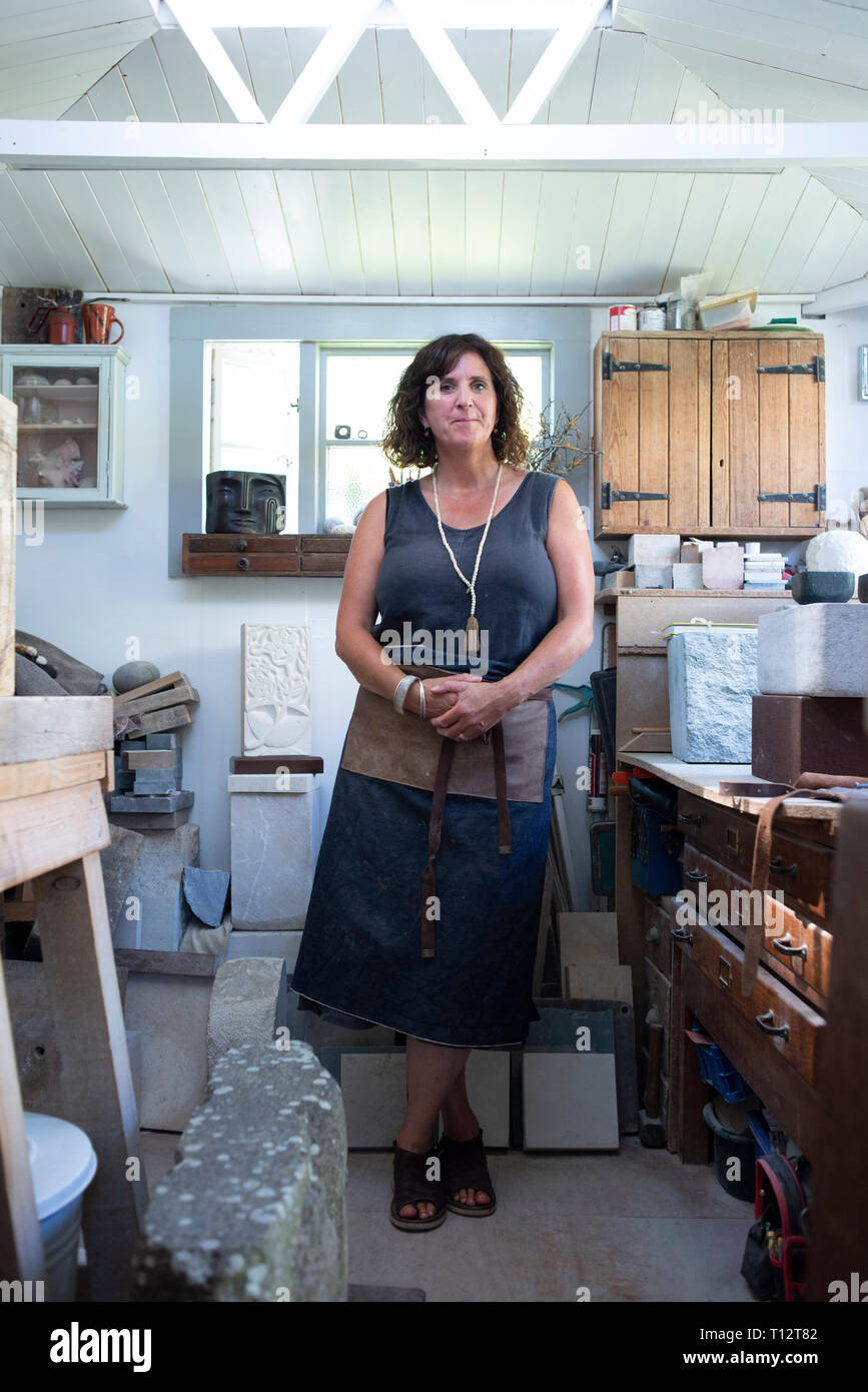 A female creative artist poses in her studio Stock Photo - Alamy