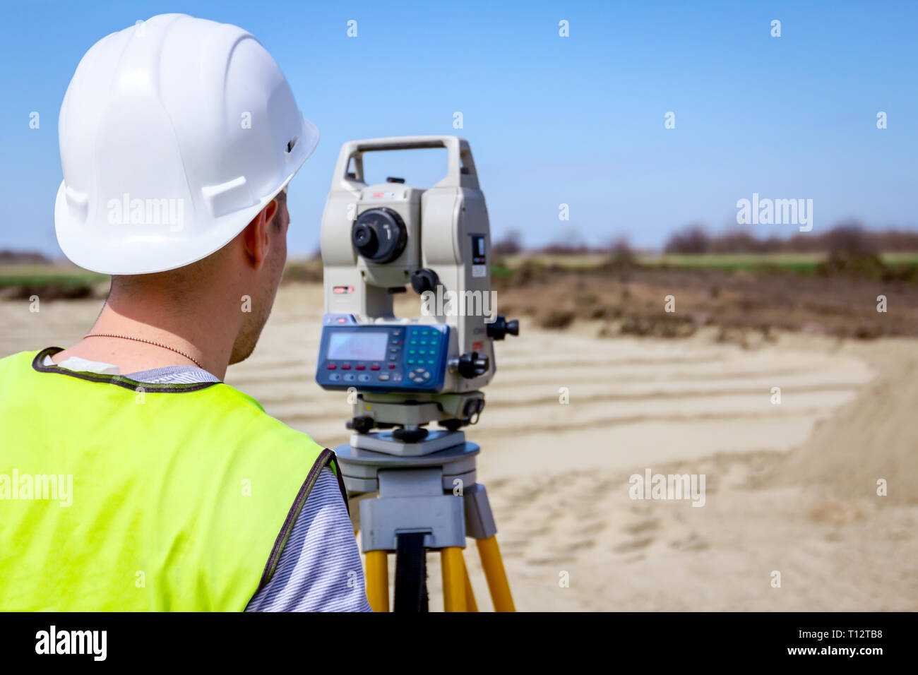 Surveyor engineer is measuring level on construction site. Surveyors ...