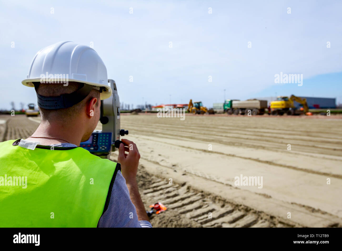 Surveyor engineer is measuring level on construction site. Surveyors ...