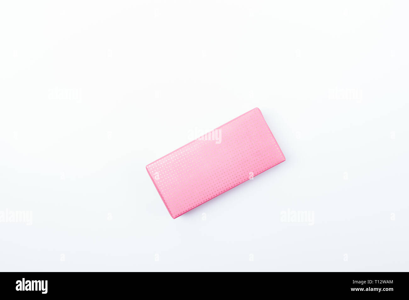 One pink gift box on white table, top view. Flat lay composition of ...