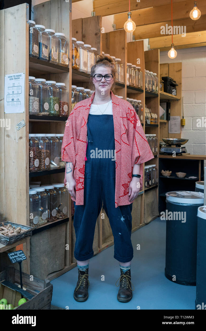 a female small business owner stands in their retail shop Stock Photo ...