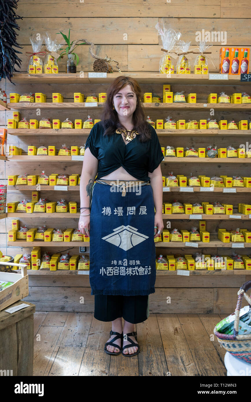 a female small business owner stands in their retail shop Stock Photo ...