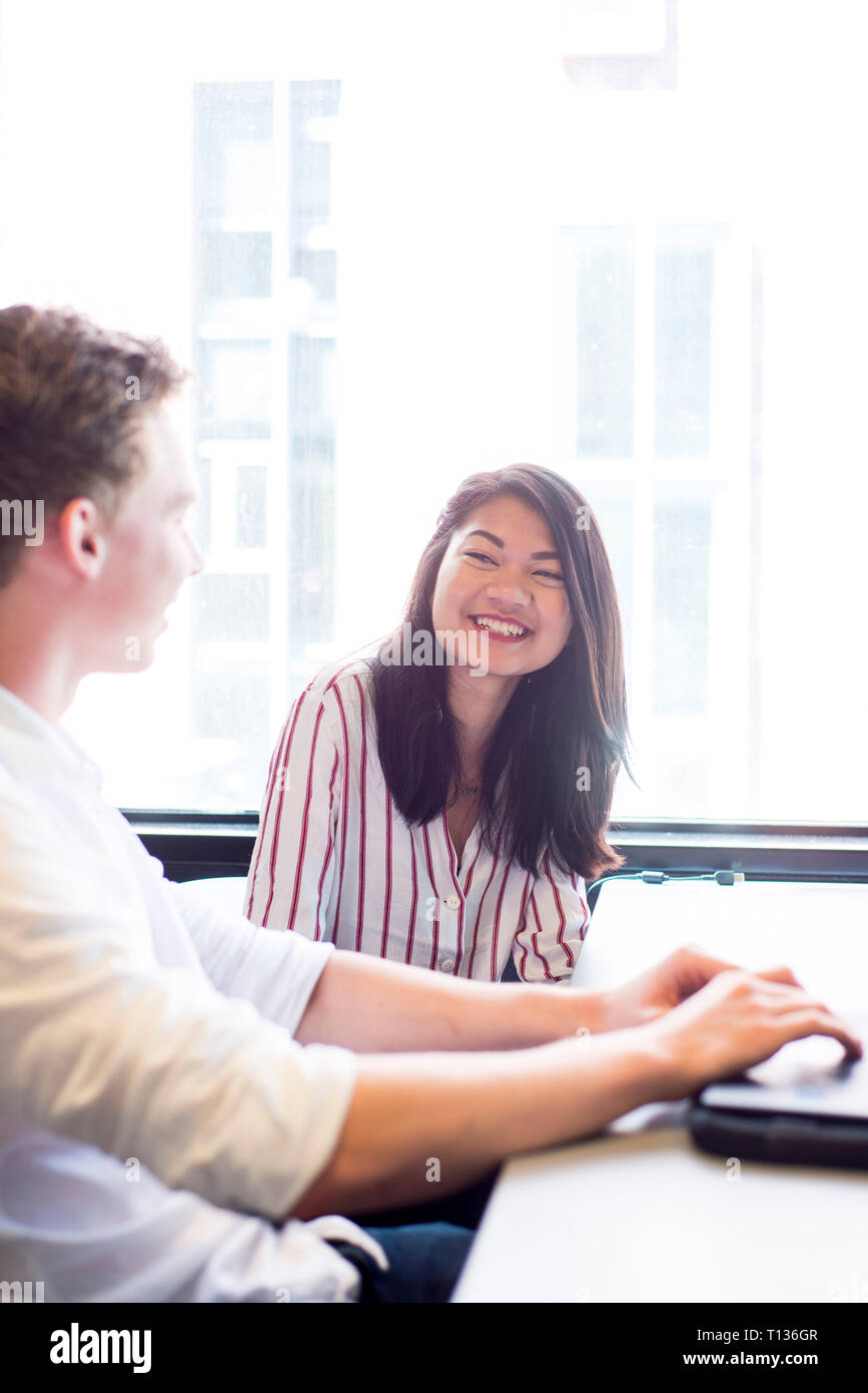 You male and female students sat down chatting and talking while ...
