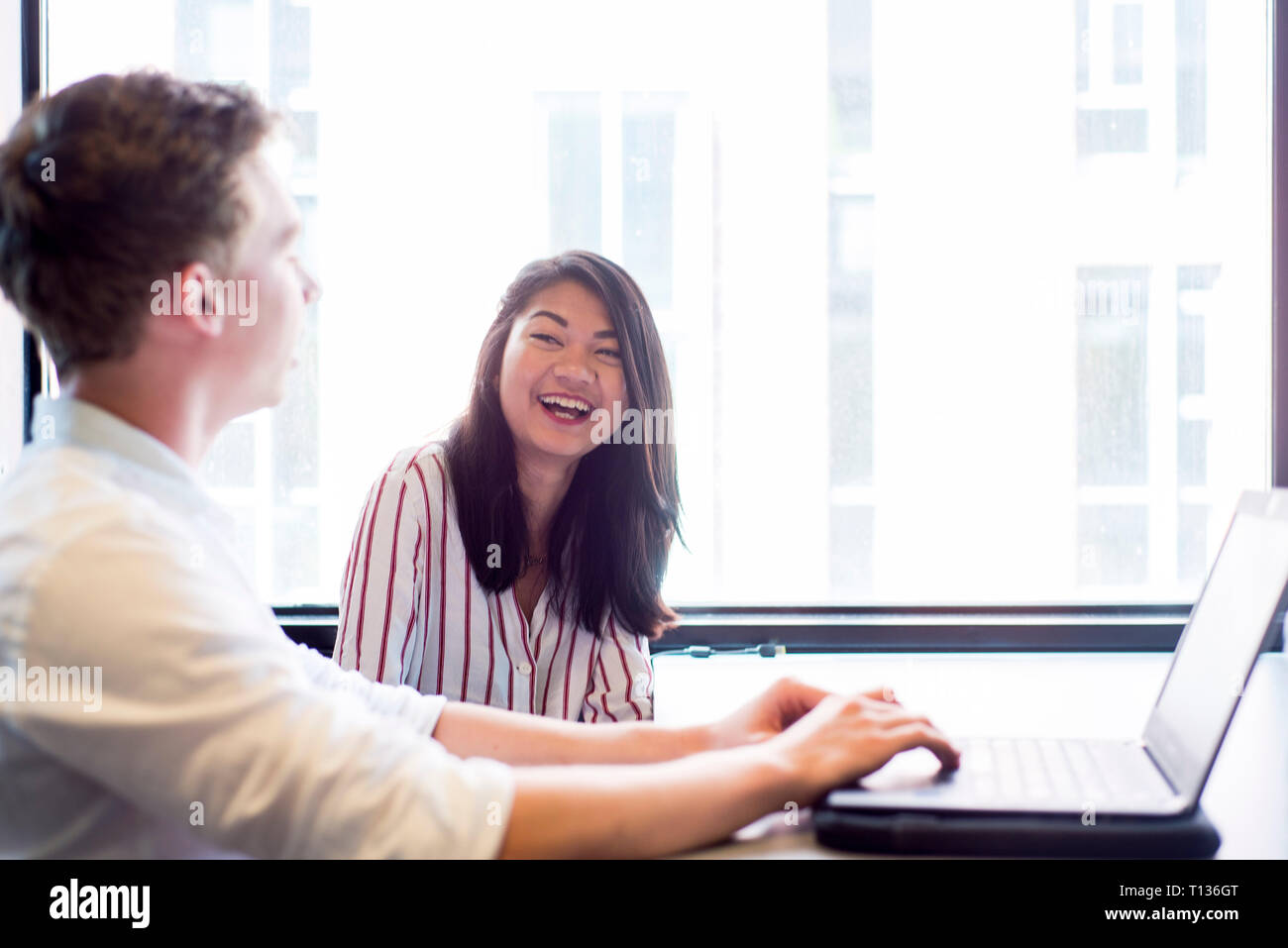 You male and female students sat down chatting and talking while ...