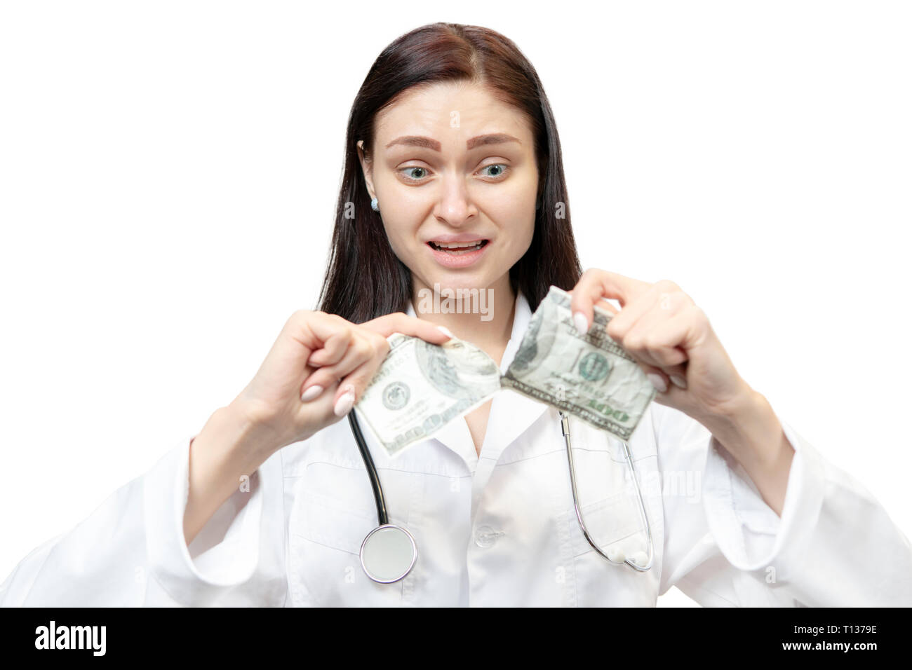 serious doctor with horror breaks crumpled hundred dollar bill ...