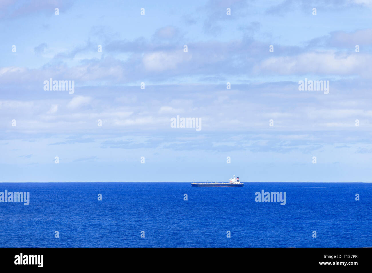 Industrial tanker sailing across ocean horizon Stock Photo - Alamy