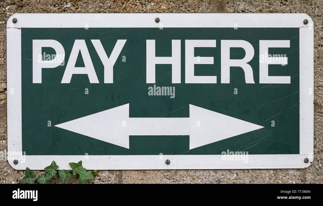 Pay Here sign Stock Photo - Alamy