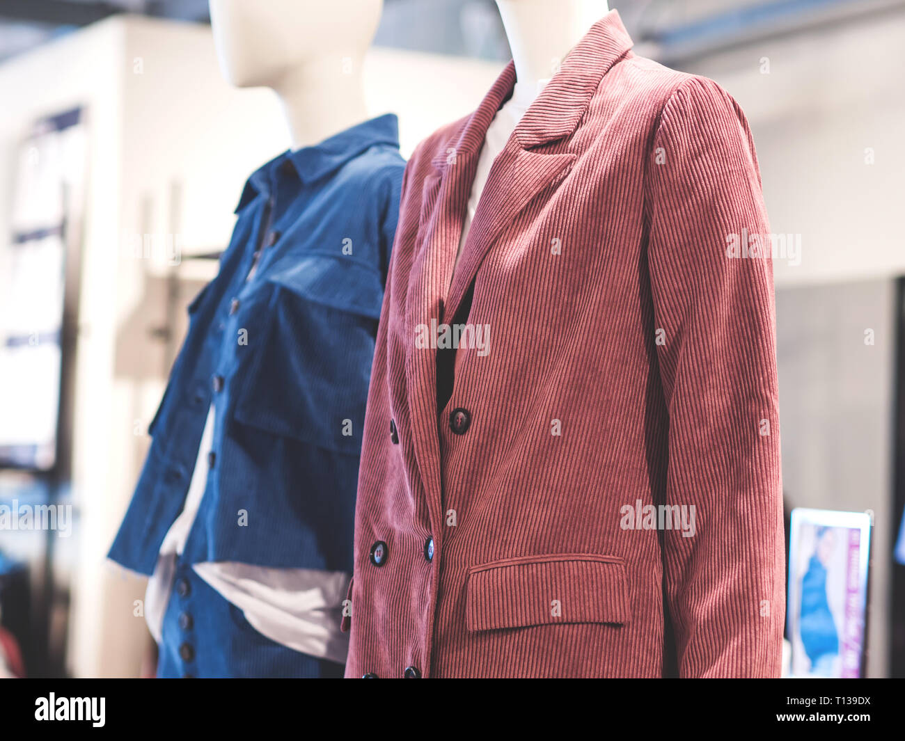 White mannequin wearing color casual jackets in a fast fashion store ...