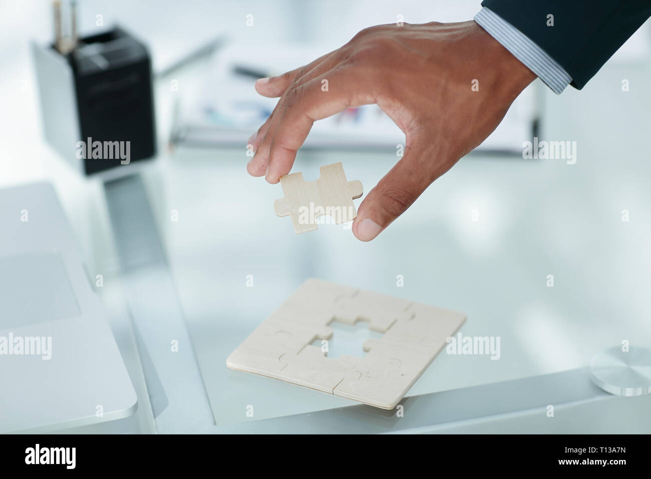 closeup. the businessman is a puzzle,sitting behind a Desk Stock Photo ...