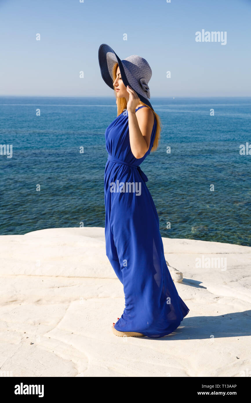 Pretty blond woman in the blue dress at the beach in Cyprus Stock Photo ...