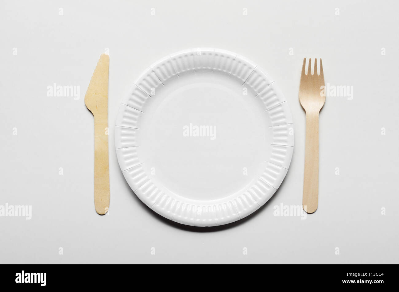 Wooden single use kitchenware and paper plate on white background ...