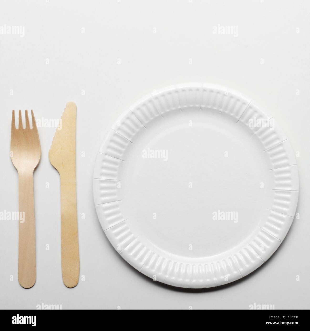 Wooden single use kitchenware and paper plate on white background ...