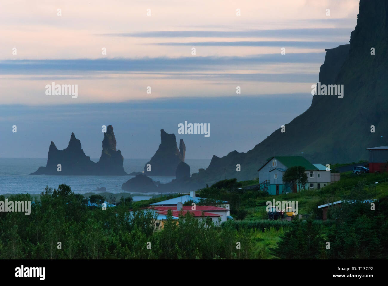 Houses and basalt sea stacks in the ocean, Vik, Iceland Stock Photo - Alamy