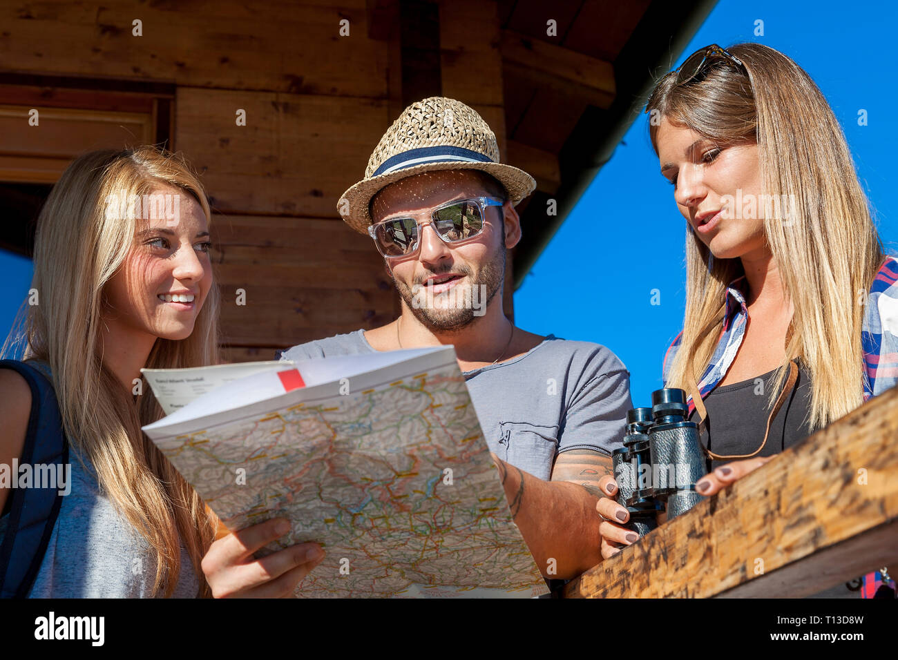 group of young hikers search on the map the right way Stock Photo - Alamy